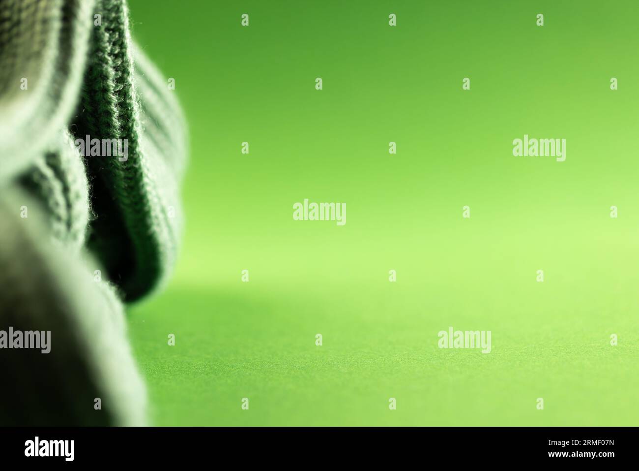 Micro close up of green wooly crochet fabric with copy space on green ...