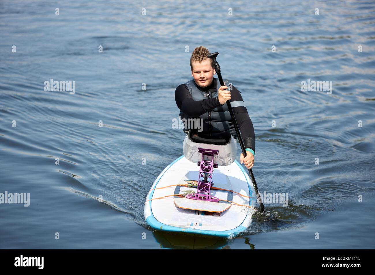 Full length portrait of smiling young boy with disability enjoying ...