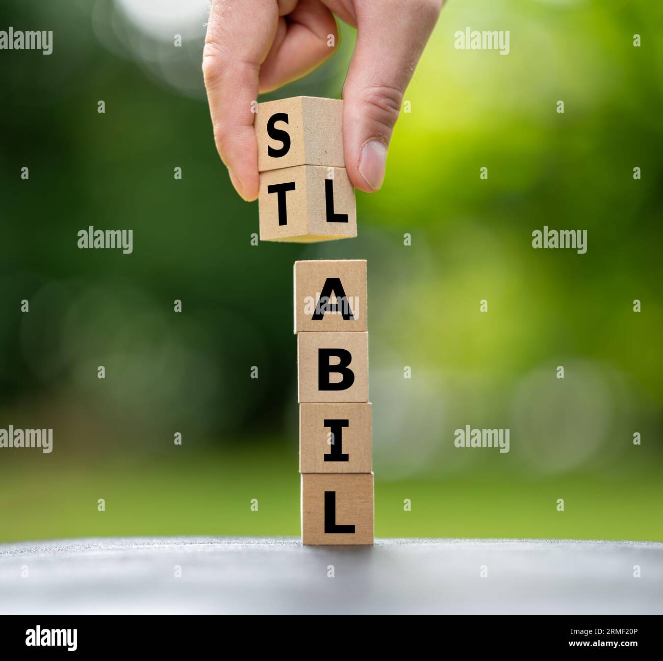A stack of wooden cubes form the German words 'labil' (unstable) and ...