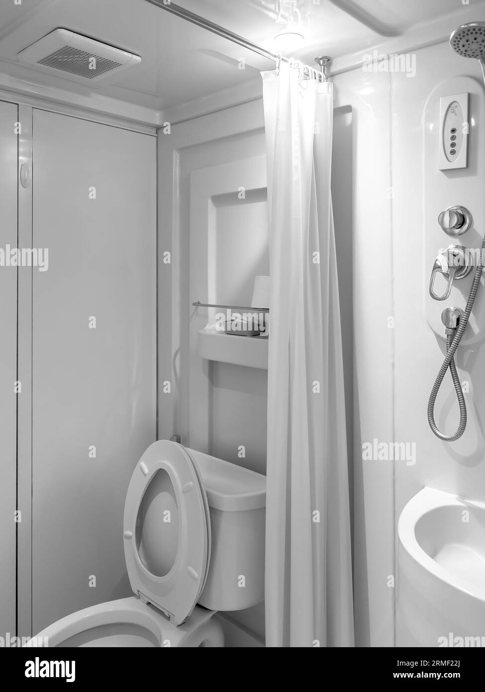 White clean narrow bathroom interior with flush toilet with curtain ...