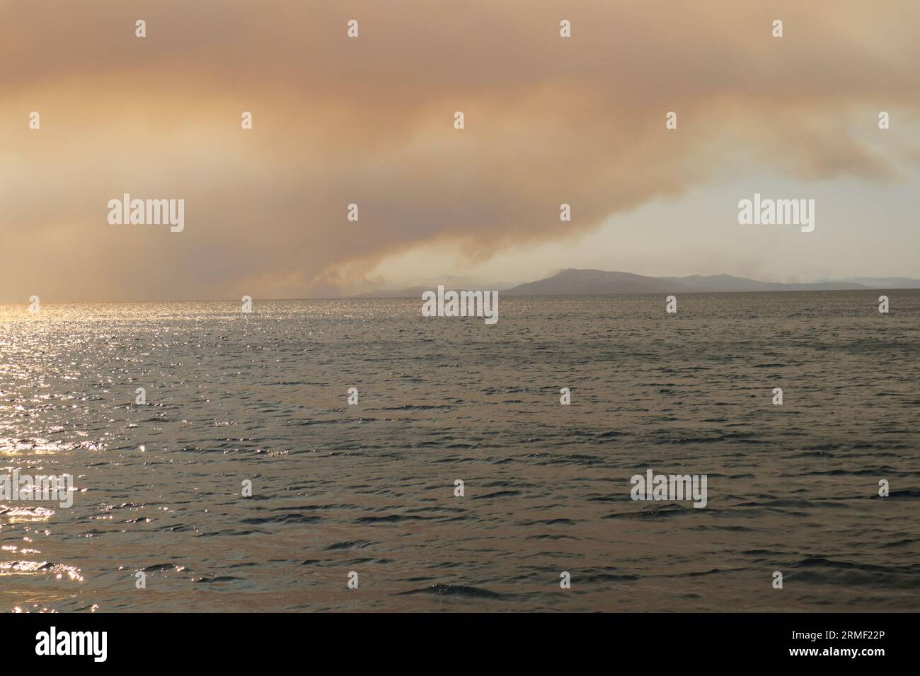 Smoke and Fires in Greek Islands summer from sea Stock Photo - Alamy