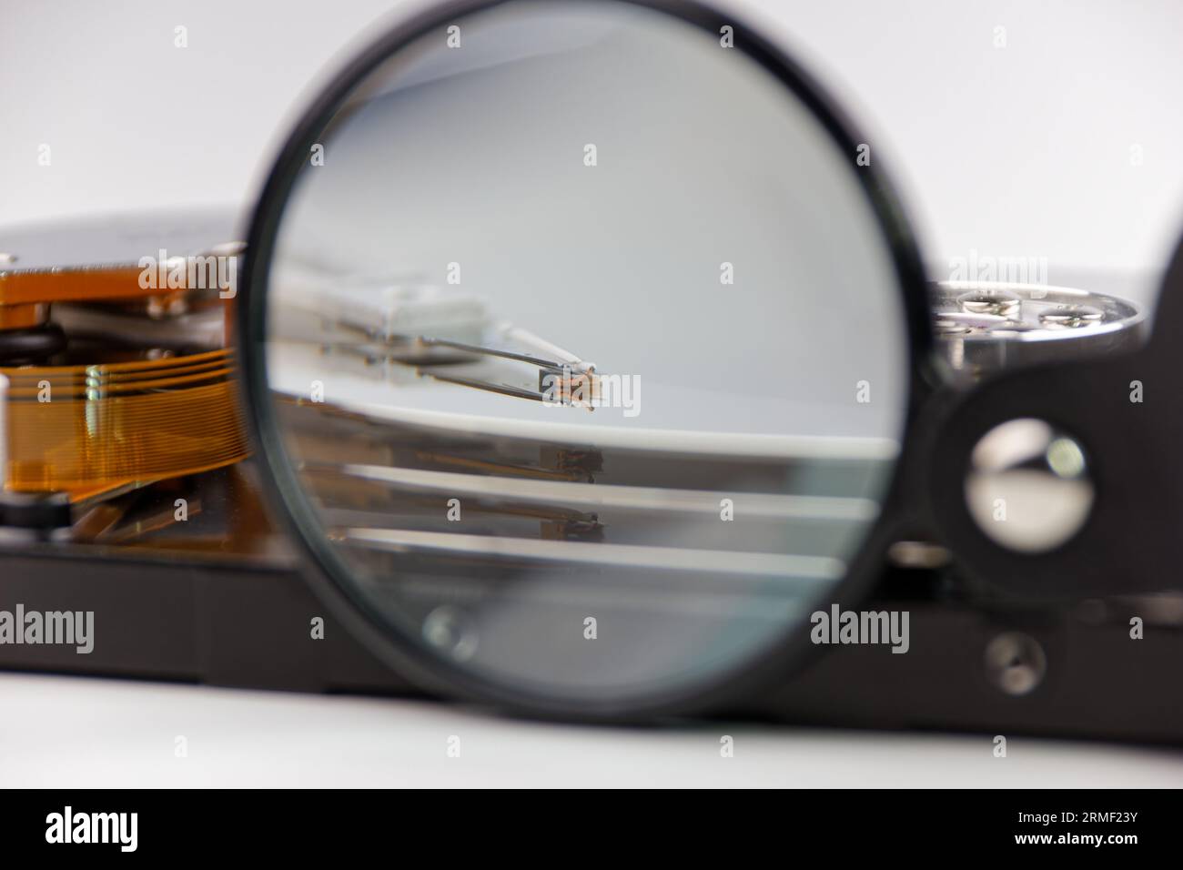 hard drive and magnifying glass, representing the process of searching ...