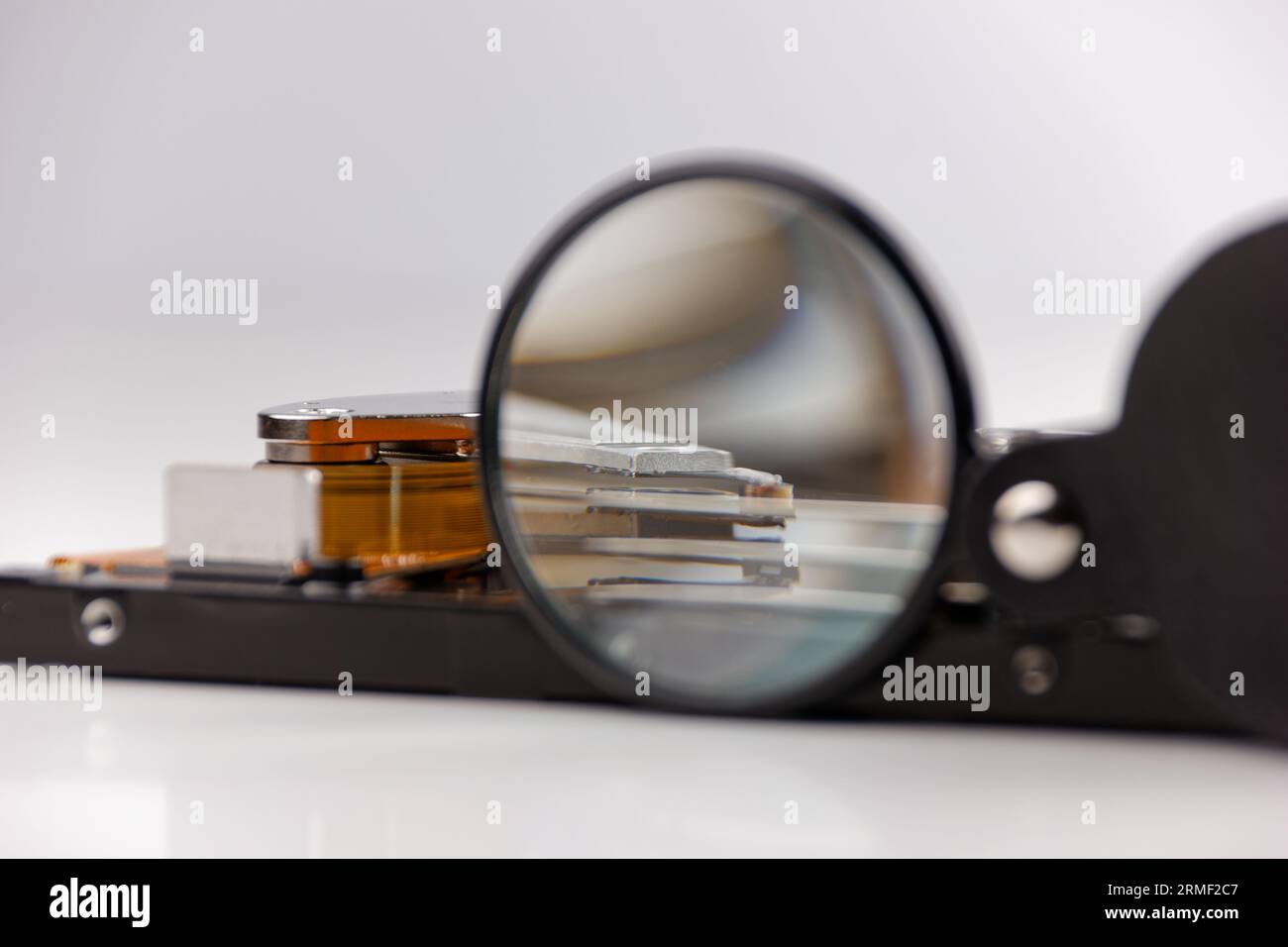 hard drive and magnifying glass, representing the process of searching ...