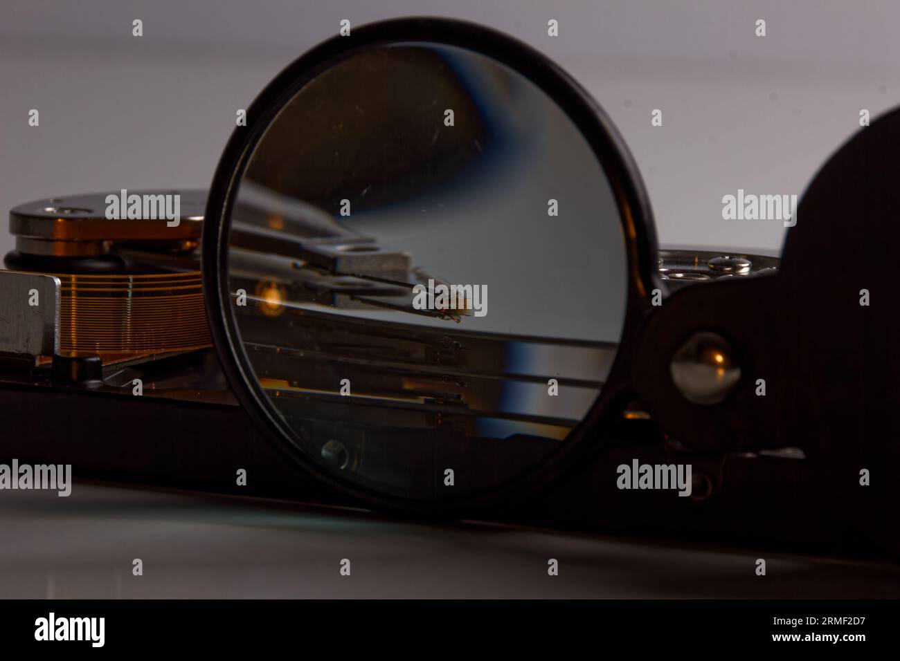 hard drive and magnifying glass, representing the process of searching ...