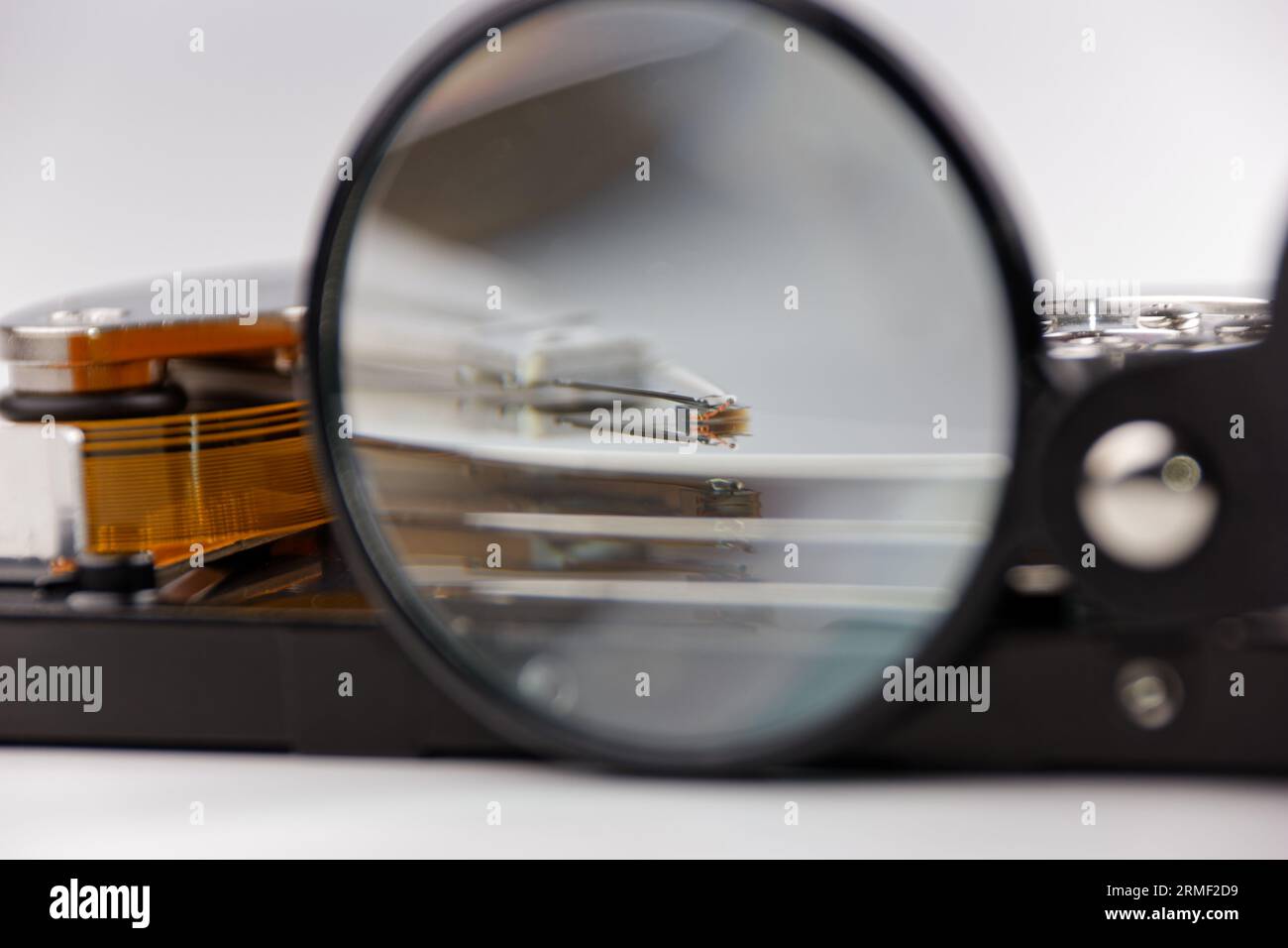 hard drive and magnifying glass, representing the process of searching ...
