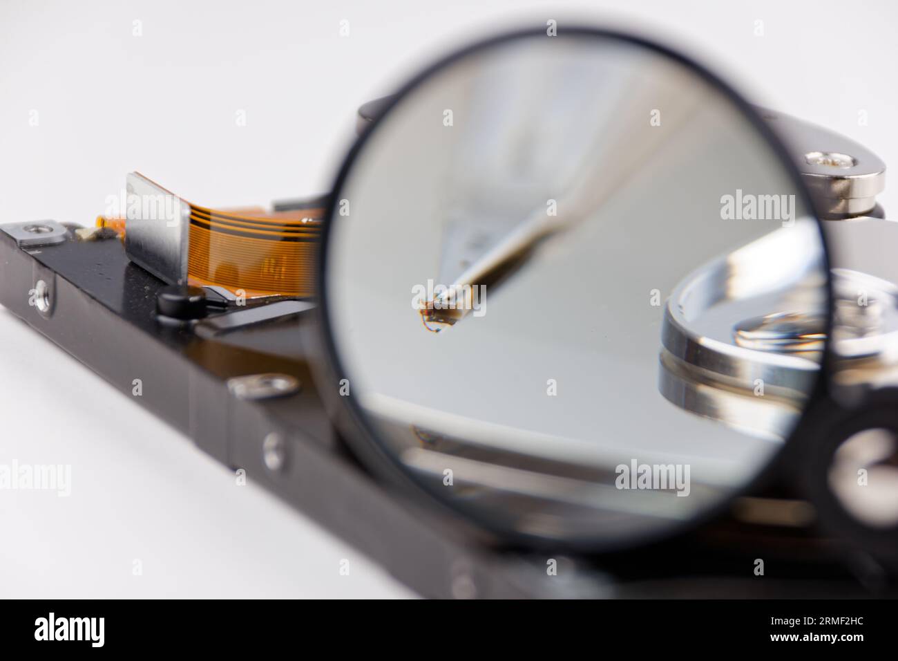 hard drive and magnifying glass, representing the process of searching ...