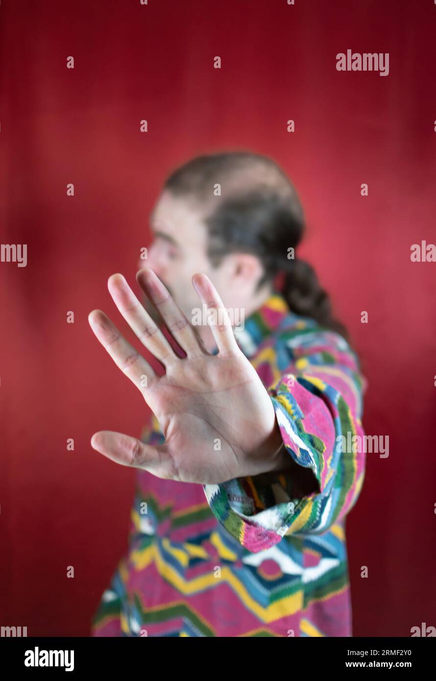 Hipster man moving head and saying No or Stop to camera with open hand ...