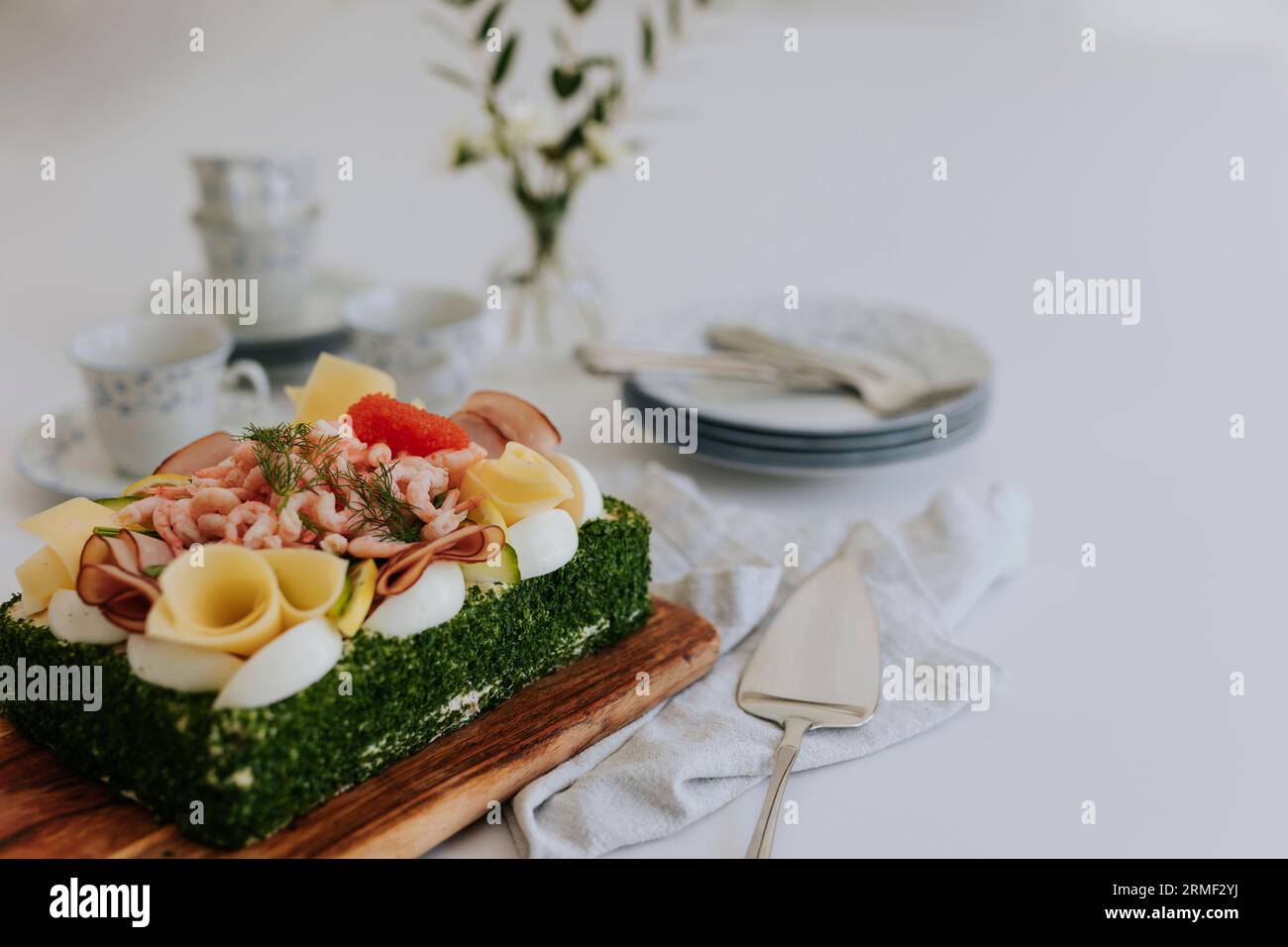 Swedish sandwich cake with shrimps, cheese, ham and eggs on wooden ...