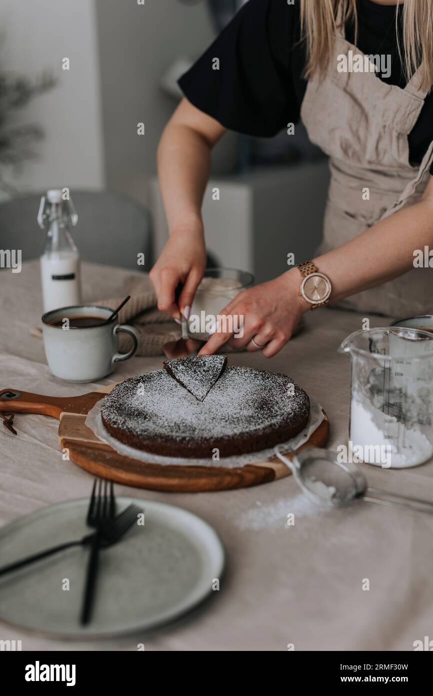 Woman cutting freshly baked hi-res stock photography and images - Alamy