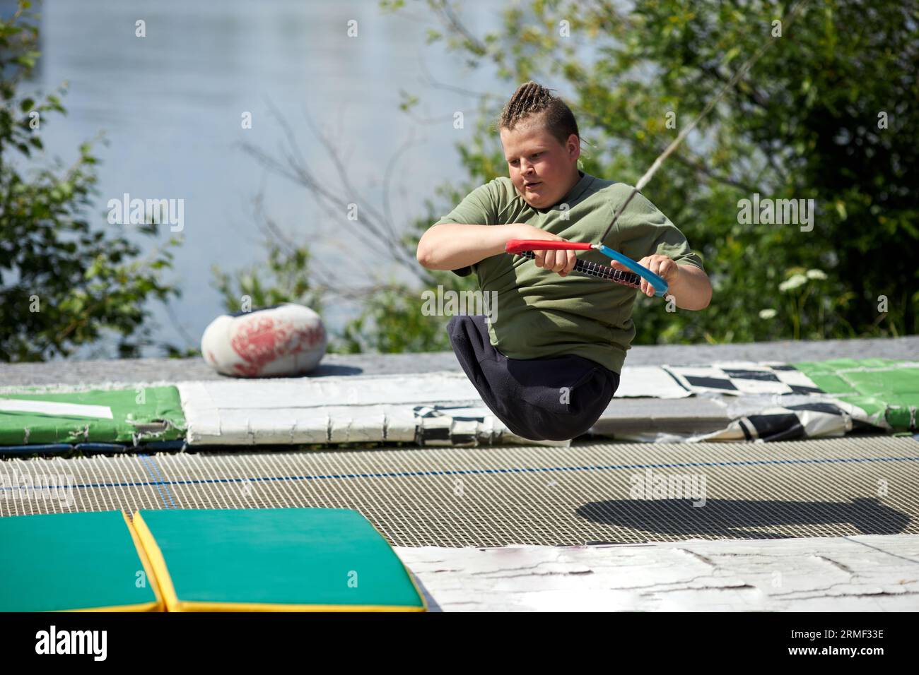 Full length portrait of teenage boy with disability enjoying ...