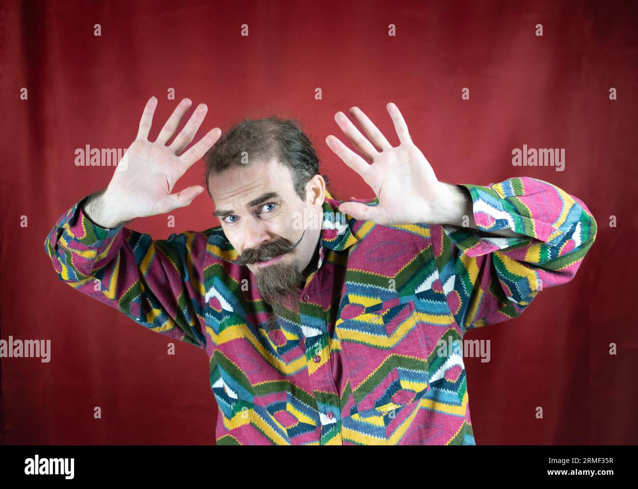 Hipster terrified man with mustache, hands raised in defense and fear ...