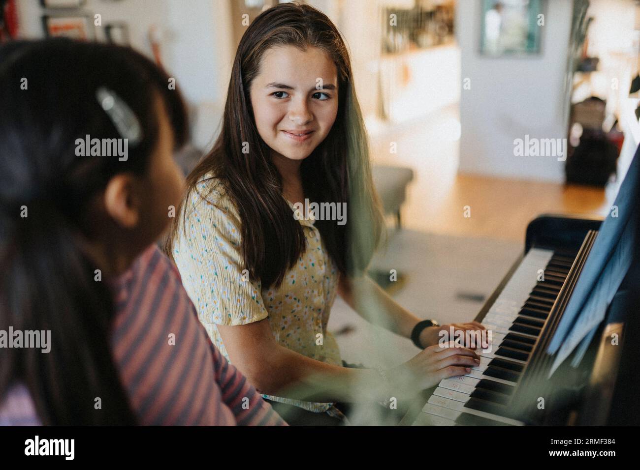 Sisters bonding over playing piano together Stock Photo - Alamy