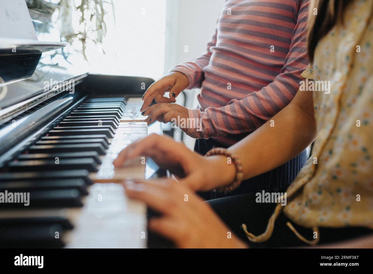 Sisters playing piano together hi-res stock photography and images - Alamy
