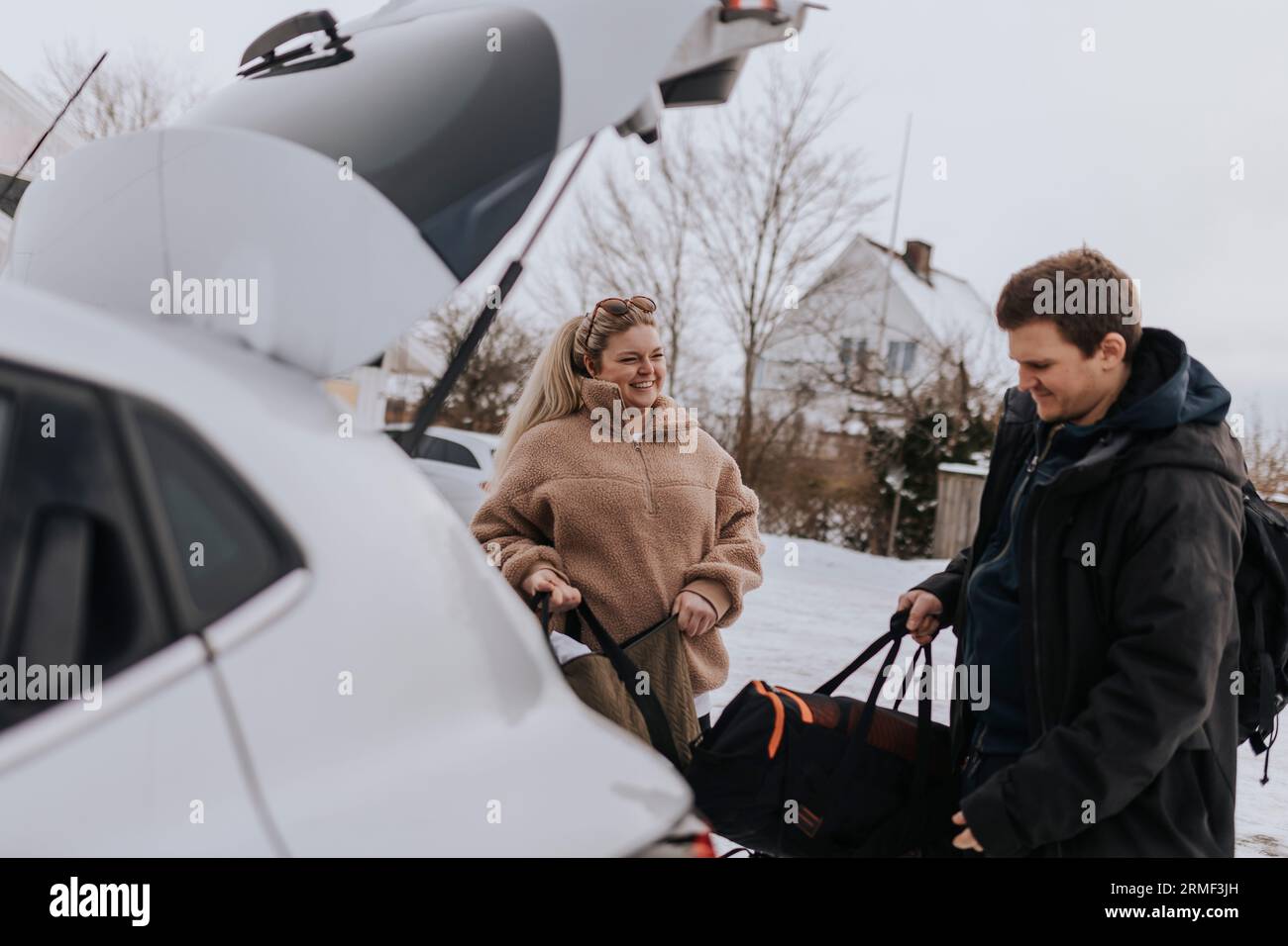People packing bag in car after workout in gym Stock Photo - Alamy