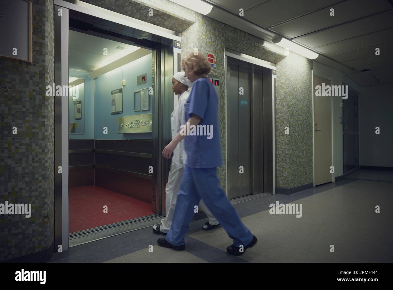Female doctors entering open lift in hospital Stock Photo - Alamy