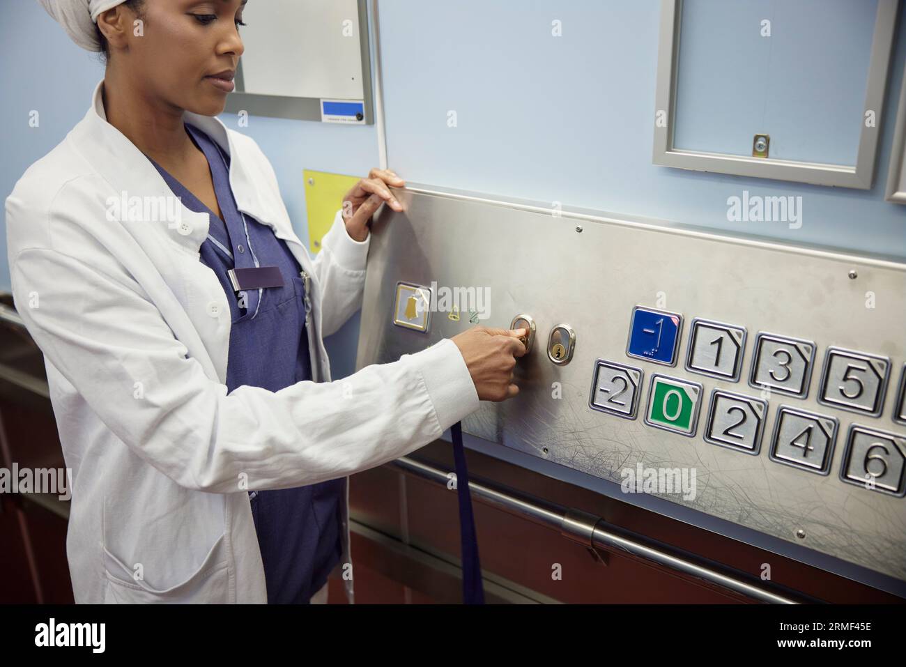 Doctor using key inside lift in hospital Stock Photo - Alamy