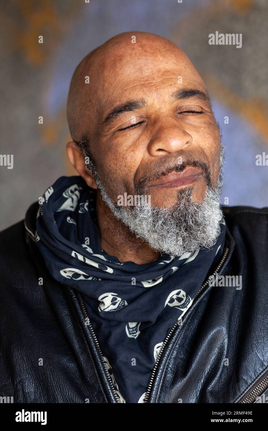 Smiling mature biker in leather jacket Stock Photo - Alamy
