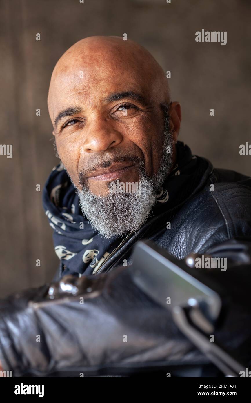 Portrait of smiling mature biker in leather jacket Stock Photo - Alamy