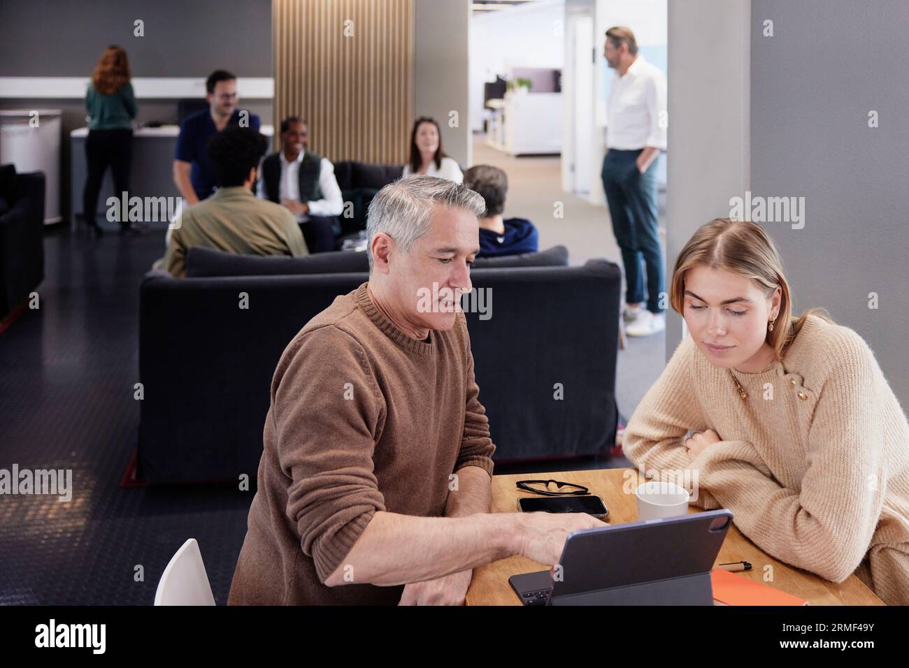 Two professionals working together in office cafeteria Stock Photo - Alamy