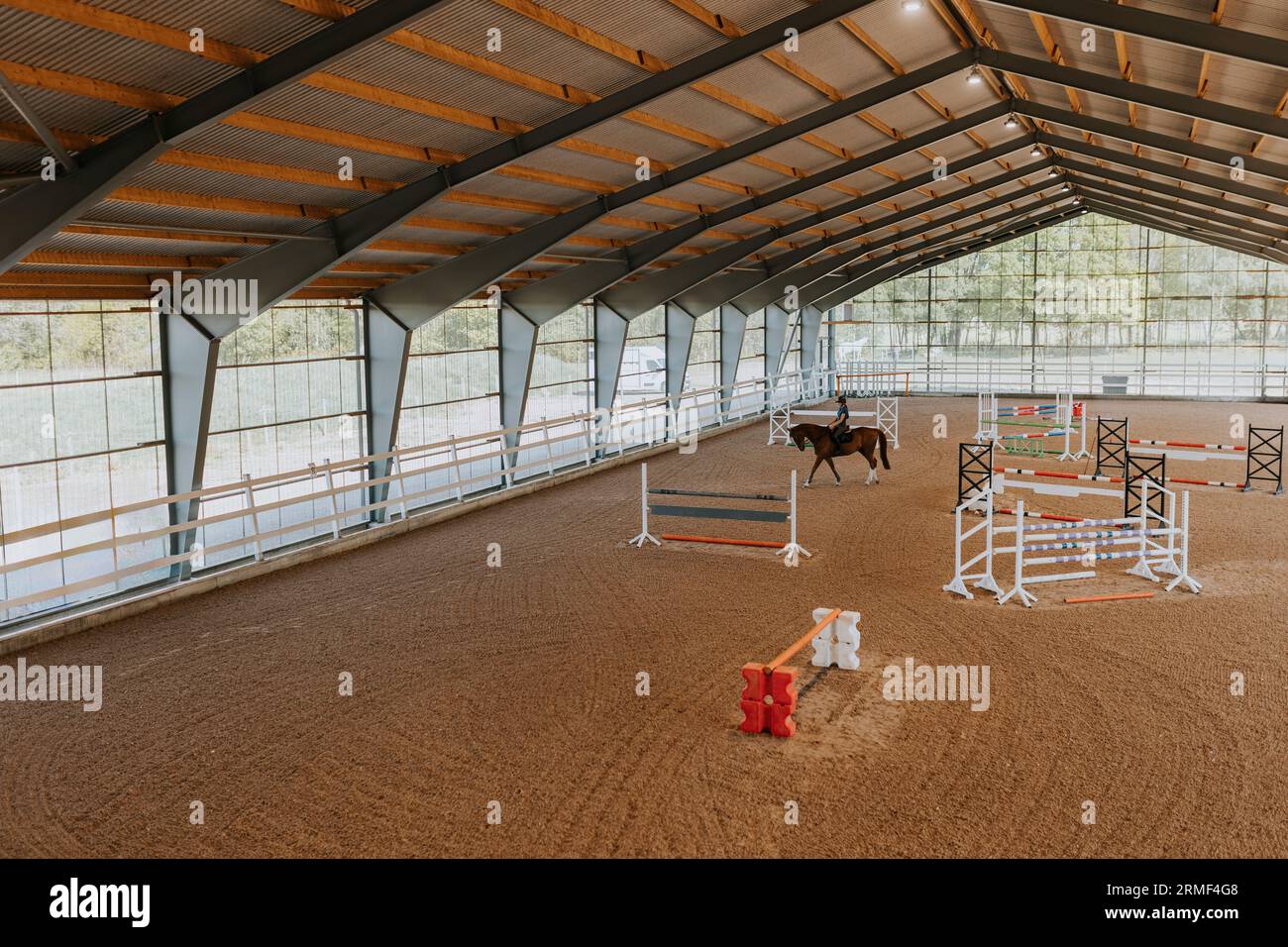 View of horse rider using indoor riding paddock Stock Photo - Alamy