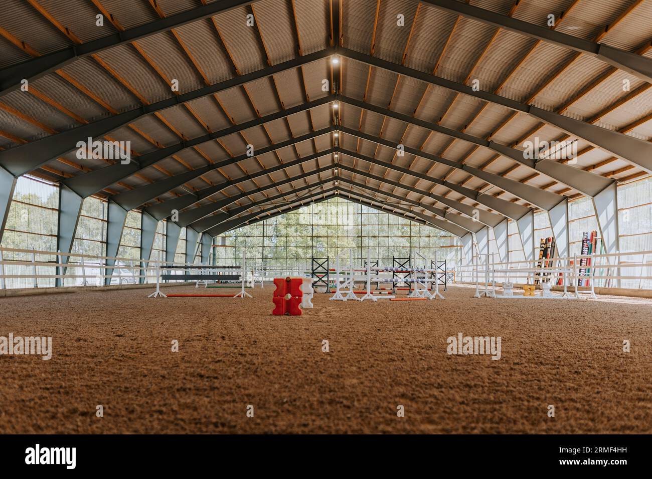 View of empty indoor riding paddock Stock Photo - Alamy