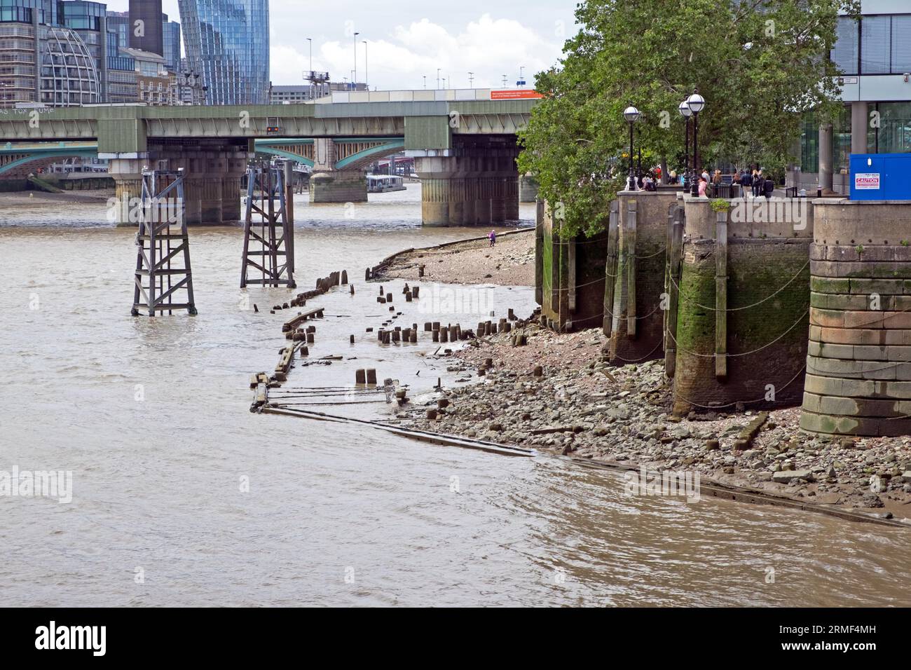 View of Thames shore at low tide and Southwark Bridge from area around ...
