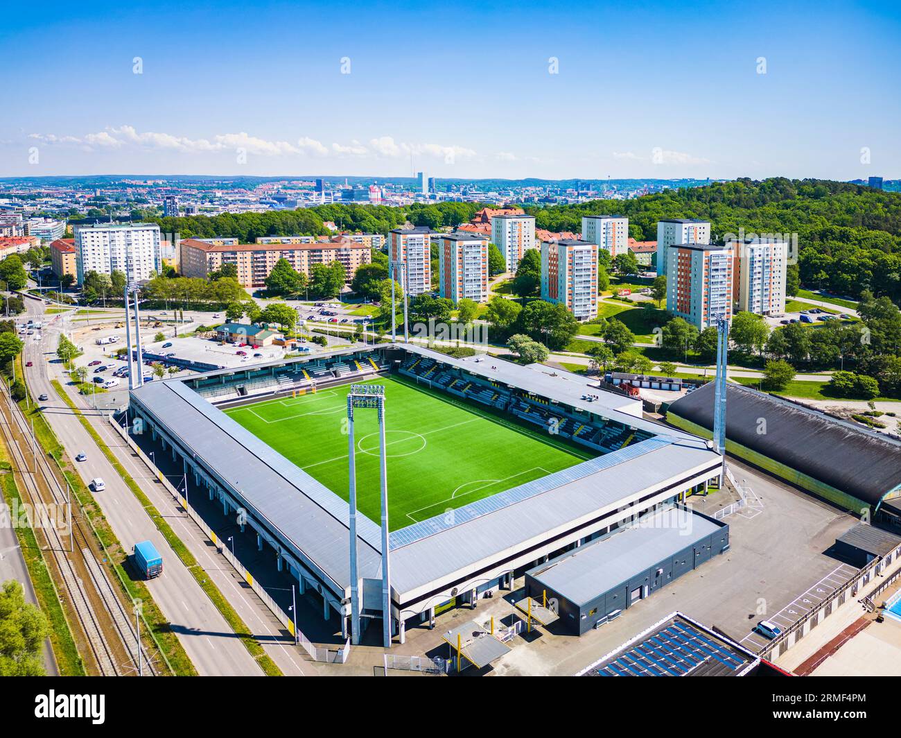 High angle view of football stadium and blocks of flats in background ...