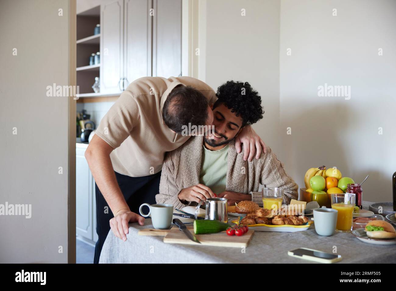 Gay couple eating breakfast home hi-res stock photography and images ...