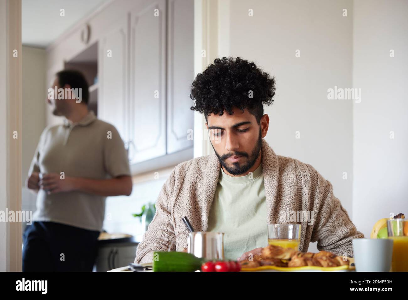 Gay couple eating breakfast at home Stock Photo - Alamy