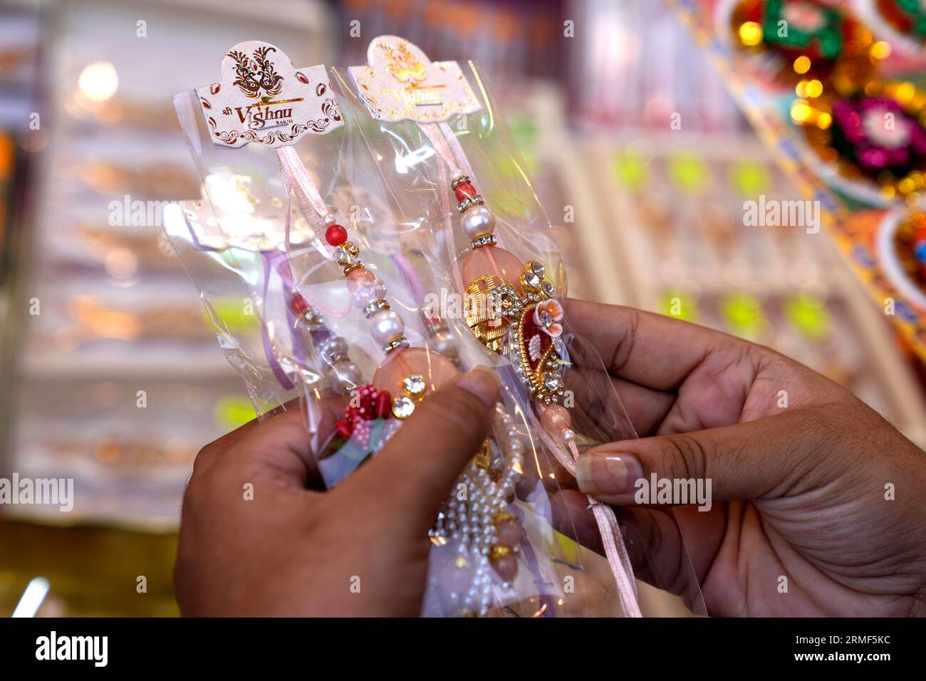 A woman shops for 'Rakhi', or a sacred thread, ahead of 'Raksha Bandhan ...