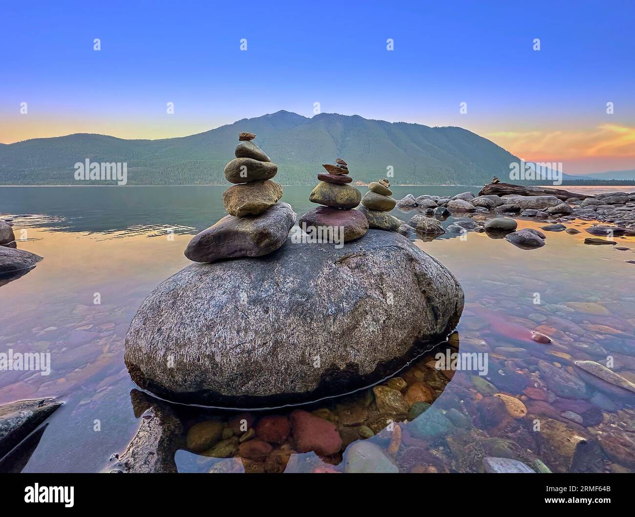Rocks stacked on a large boulder at Glacier National Park, MT Stock ...