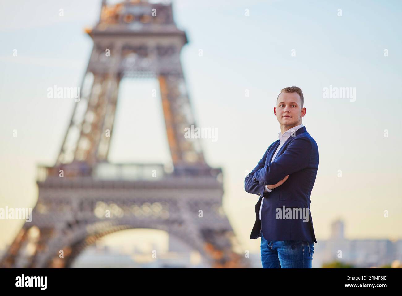 Handsome young man near the Eiffel tower in Paris Stock Photo - Alamy