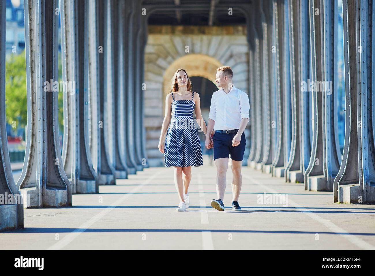 Romantic couple walking along Bir-Hakeim bridge in Paris, France Stock ...