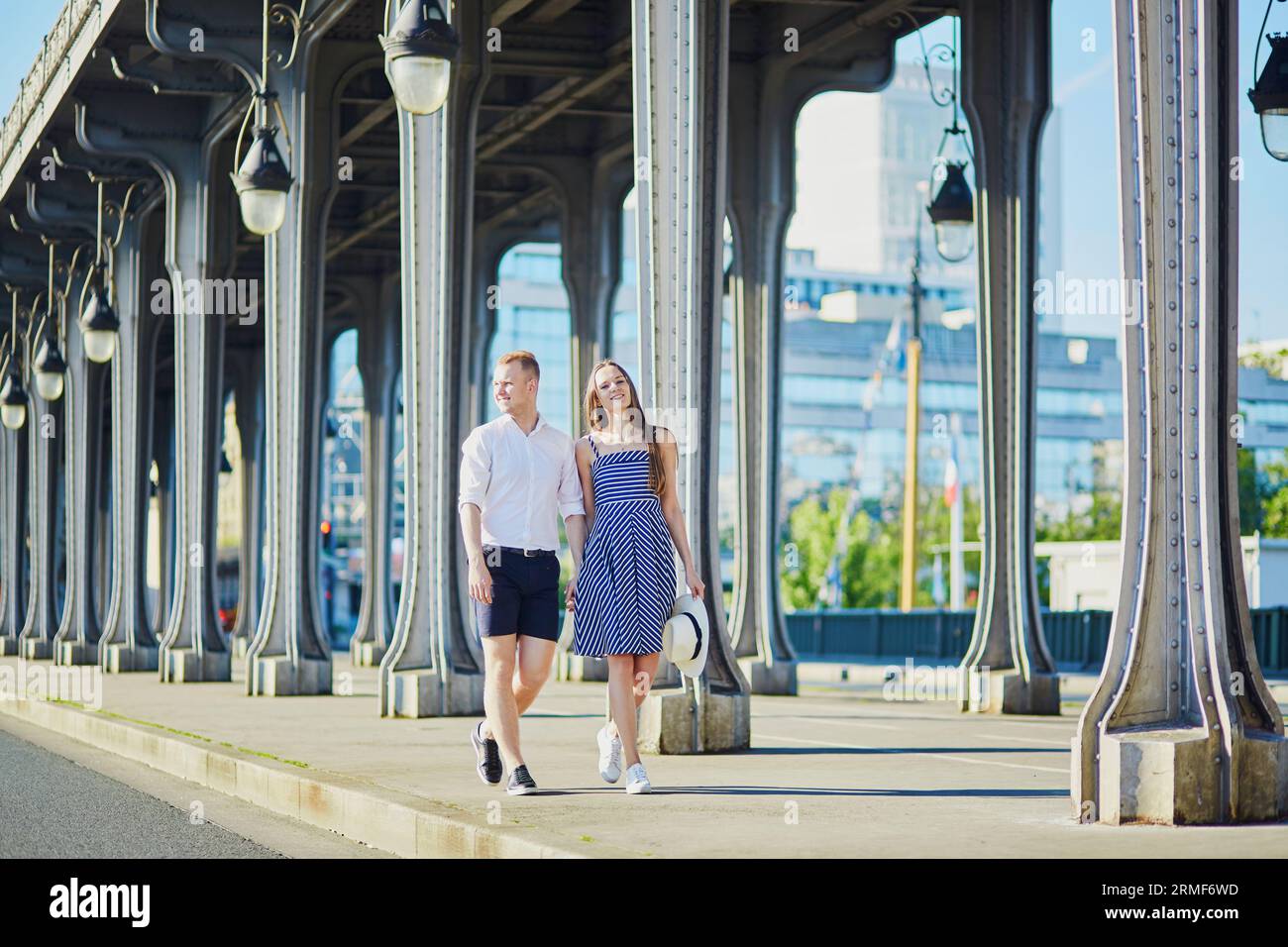 Romantic couple walking along Bir-Hakeim bridge in Paris, France Stock ...