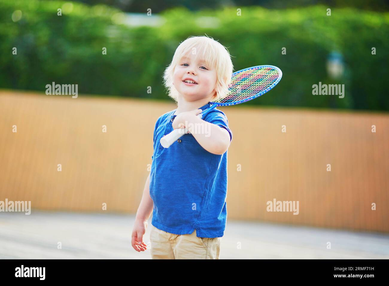 Adorable little boy playing badminton on the playground. Outdoor summer ...