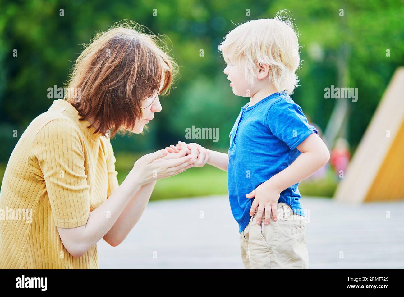 Mother comforting her crying son after he injured his hand Stock Photo ...