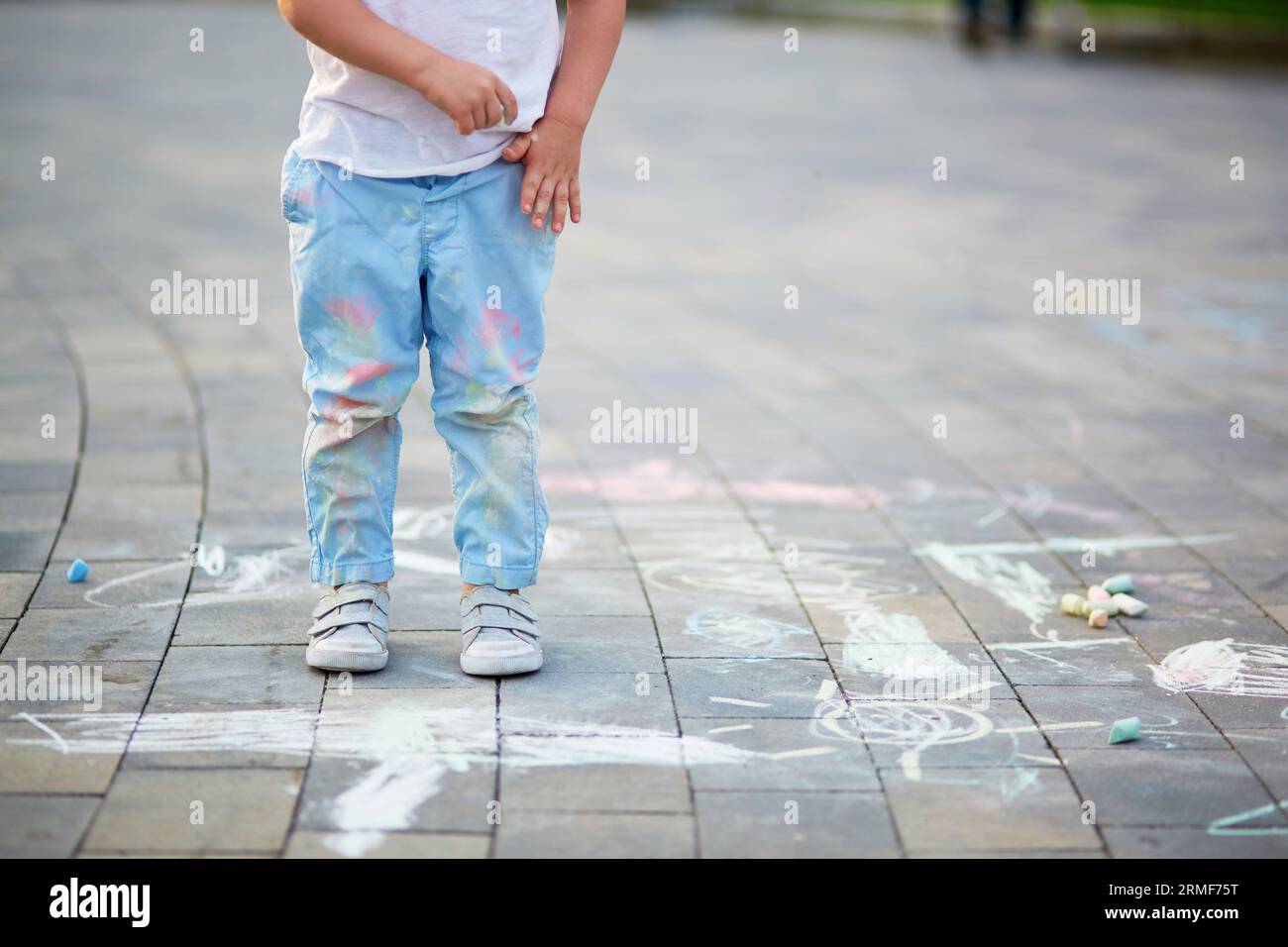 Closeup of little boy's pants stained with chalks. Children drawing on ...