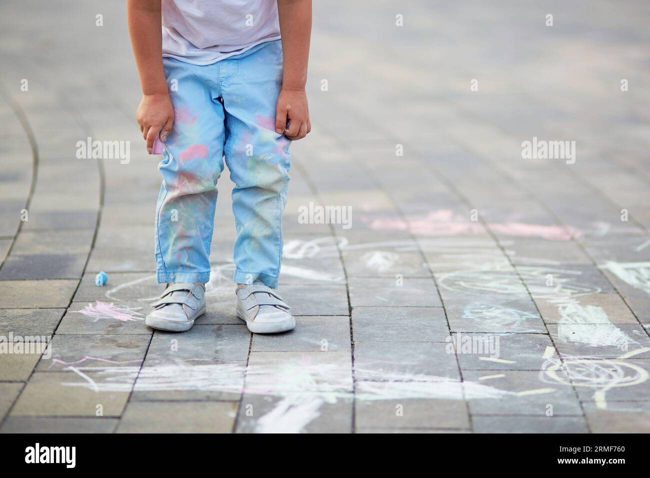 Closeup of little boy's pants stained with chalks. Children drawing on ...