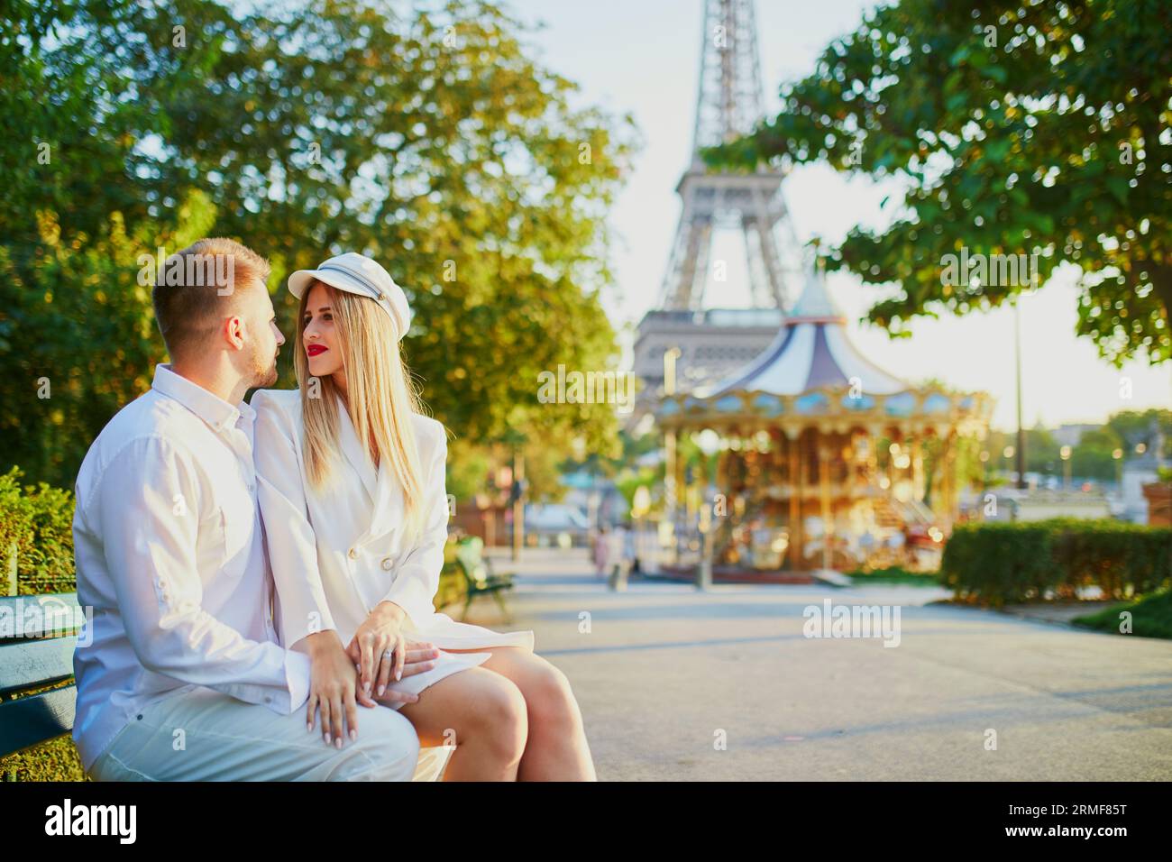 Romantic couple having a date near the Eiffel tower. Tourists in Paris ...