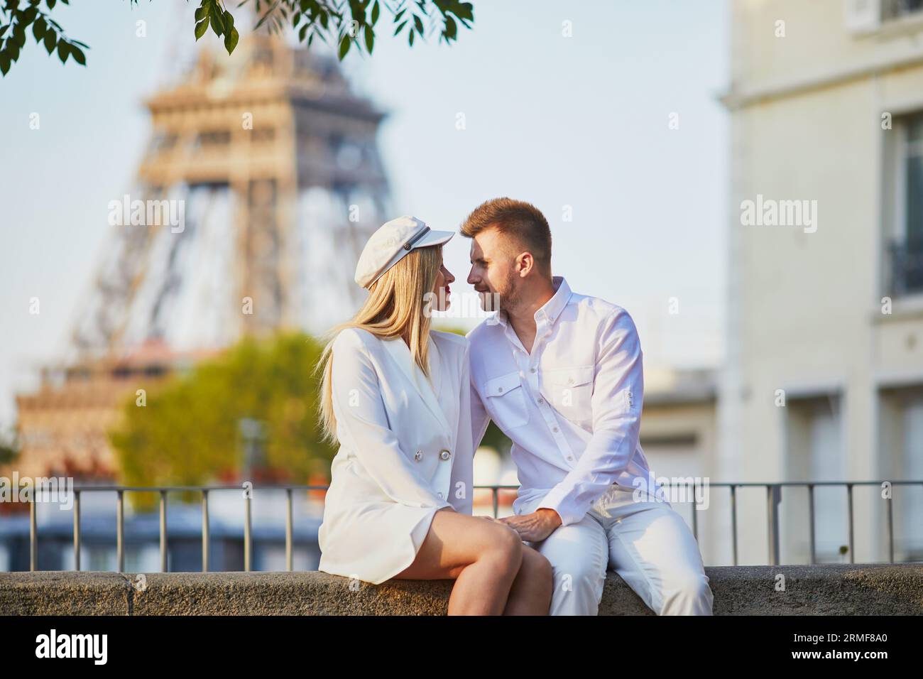 Romantic couple having a date near the Eiffel tower. Tourists in Paris ...