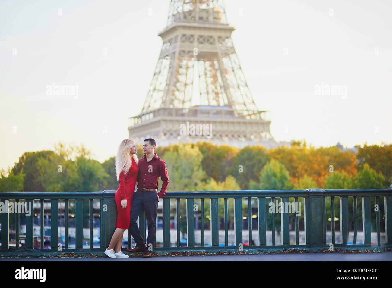 Romantic couple in love kissing on the bridge near the Eiffel tower in ...