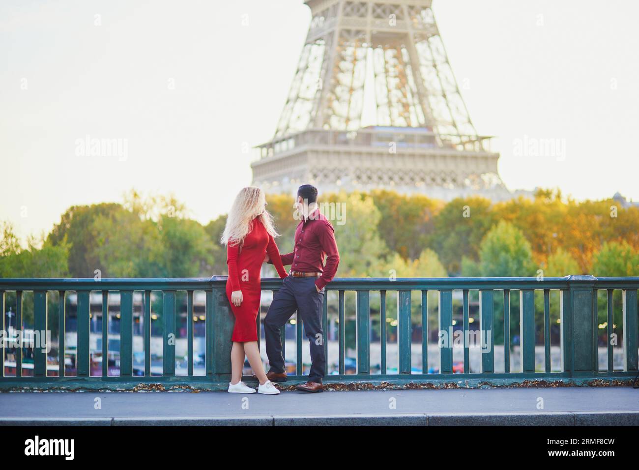 Romantic couple in love kissing on the bridge near the Eiffel tower in ...