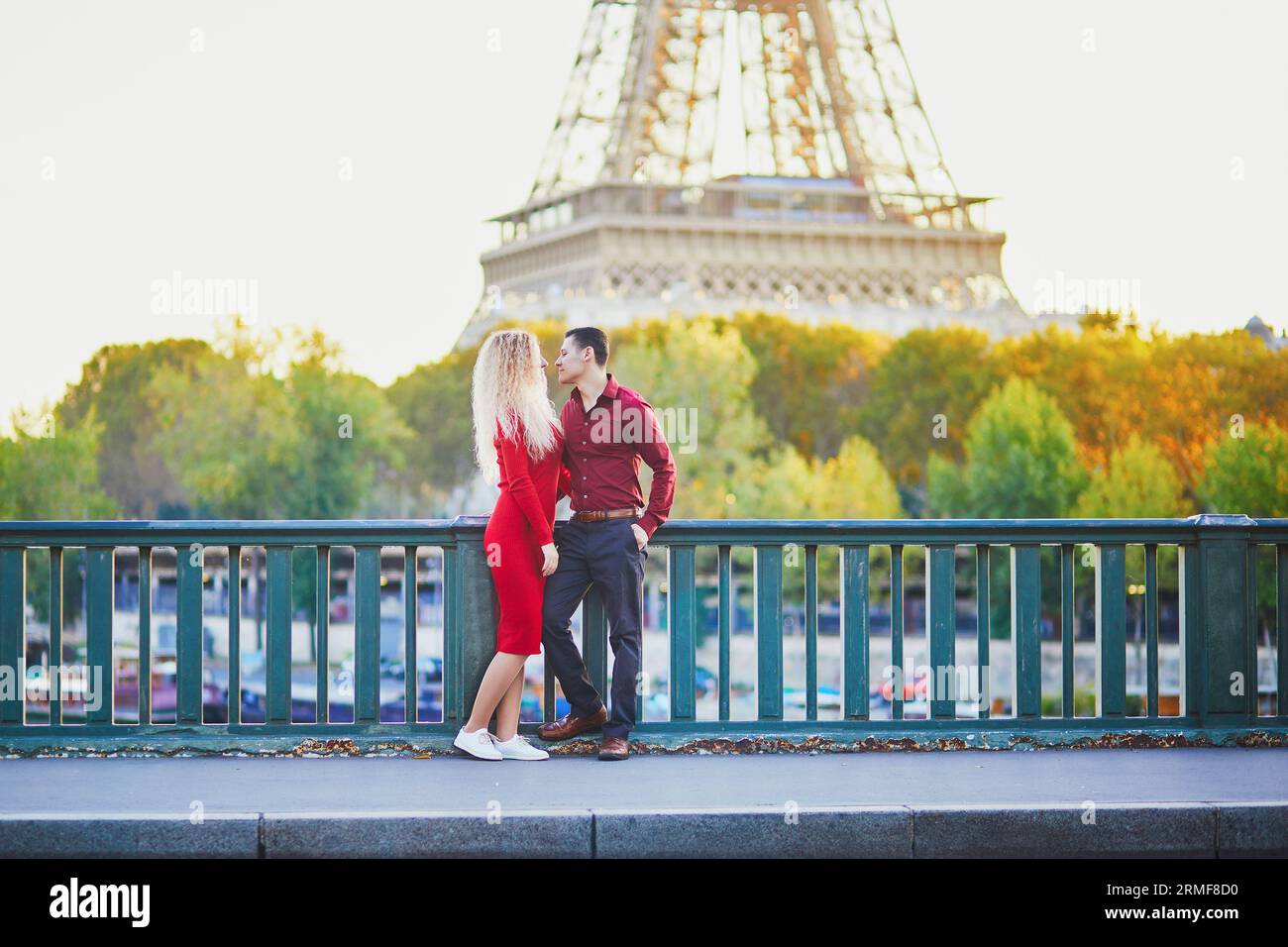 Romantic couple in love kissing on the bridge near the Eiffel tower in ...