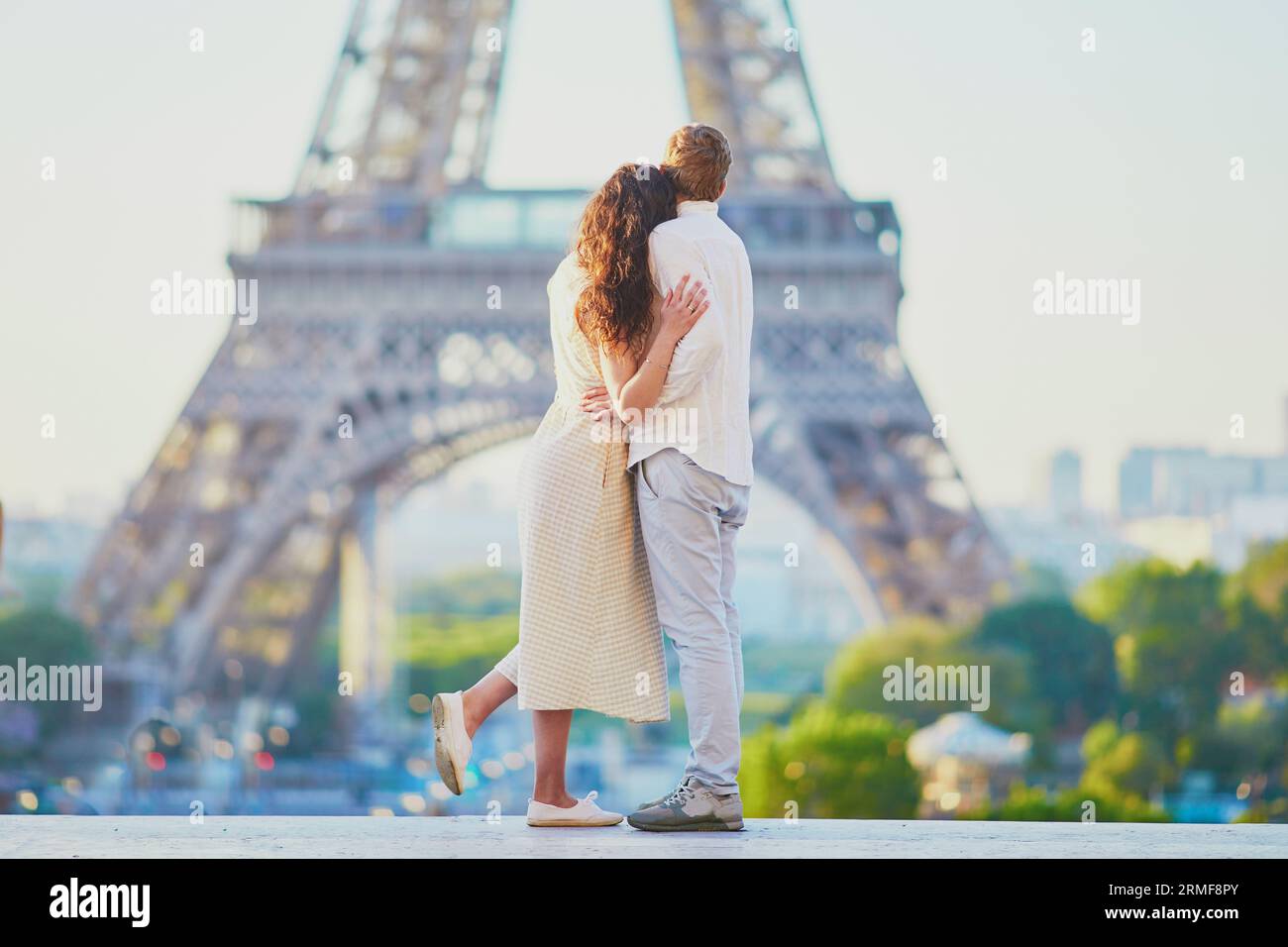 Happy romantic couple in Paris, near the Eiffel tower. Tourists ...