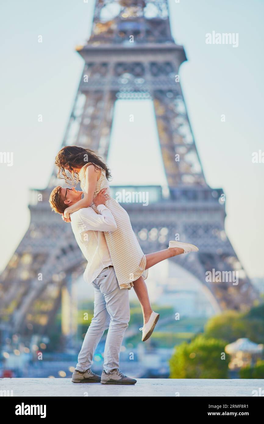 Happy romantic couple in Paris, near the Eiffel tower. Tourists ...