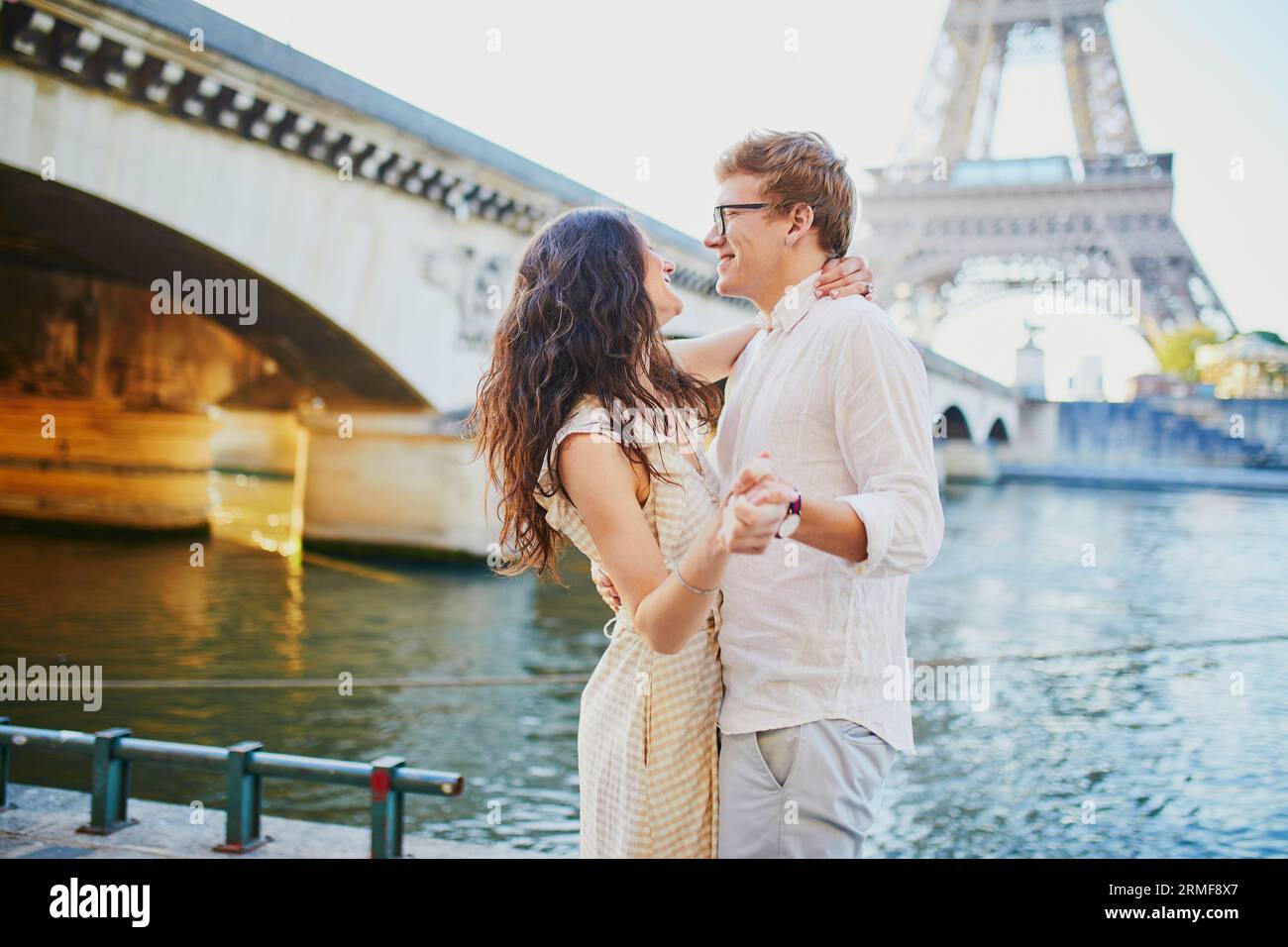 Happy romantic couple in Paris, near the Eiffel tower. Tourists ...