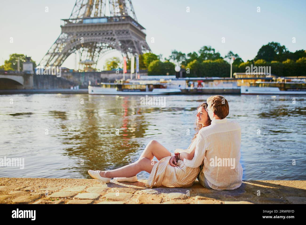 Happy romantic couple in Paris, near the Eiffel tower. Tourists ...