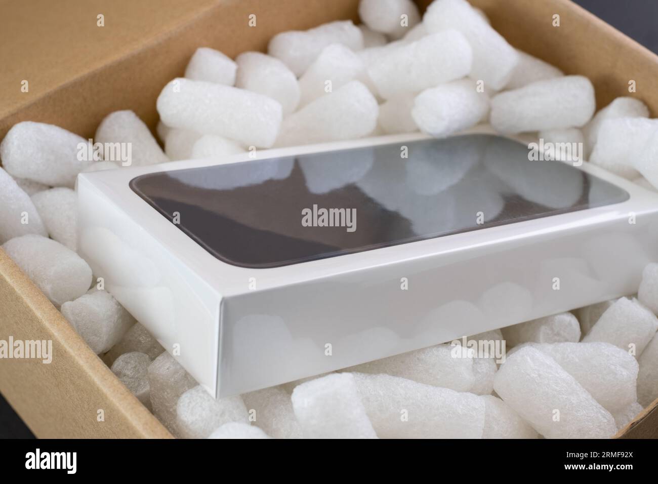 Packing Care peanuts in a cardboard box with a new device, protective ...