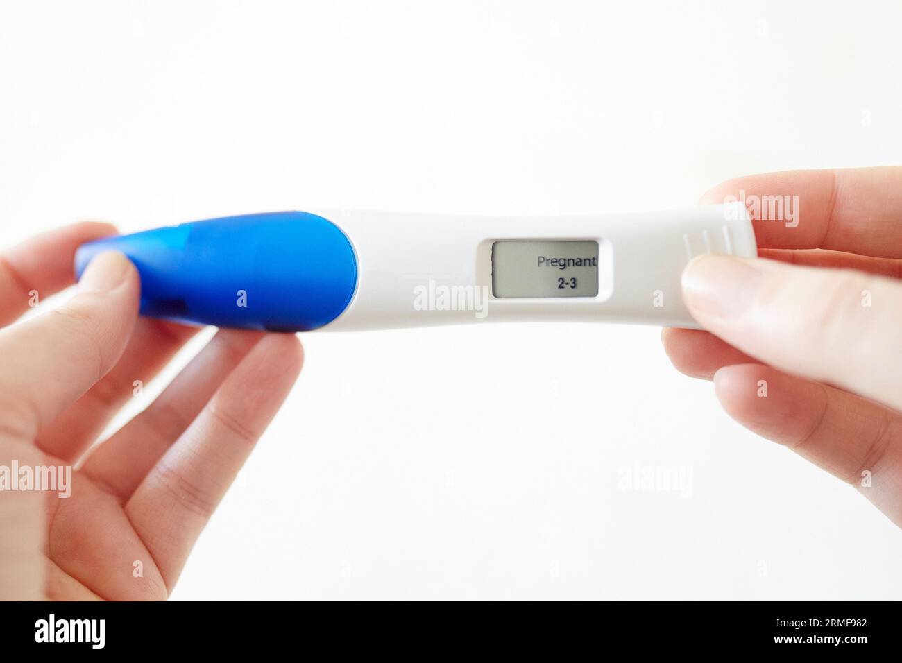 Woman hands holding positive digital pregnancy test. Pregnancy ...