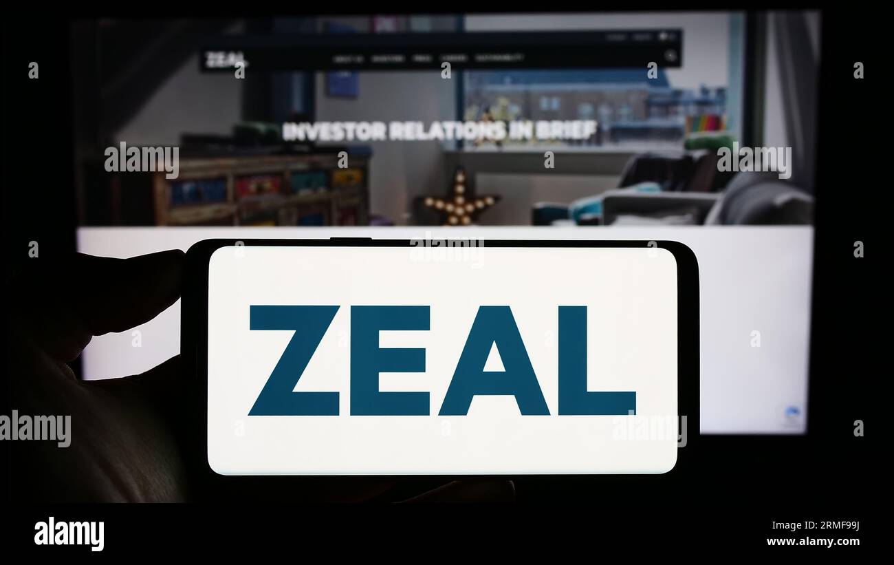 Person holding cellphone with logo of German lottery company ZEAL ...